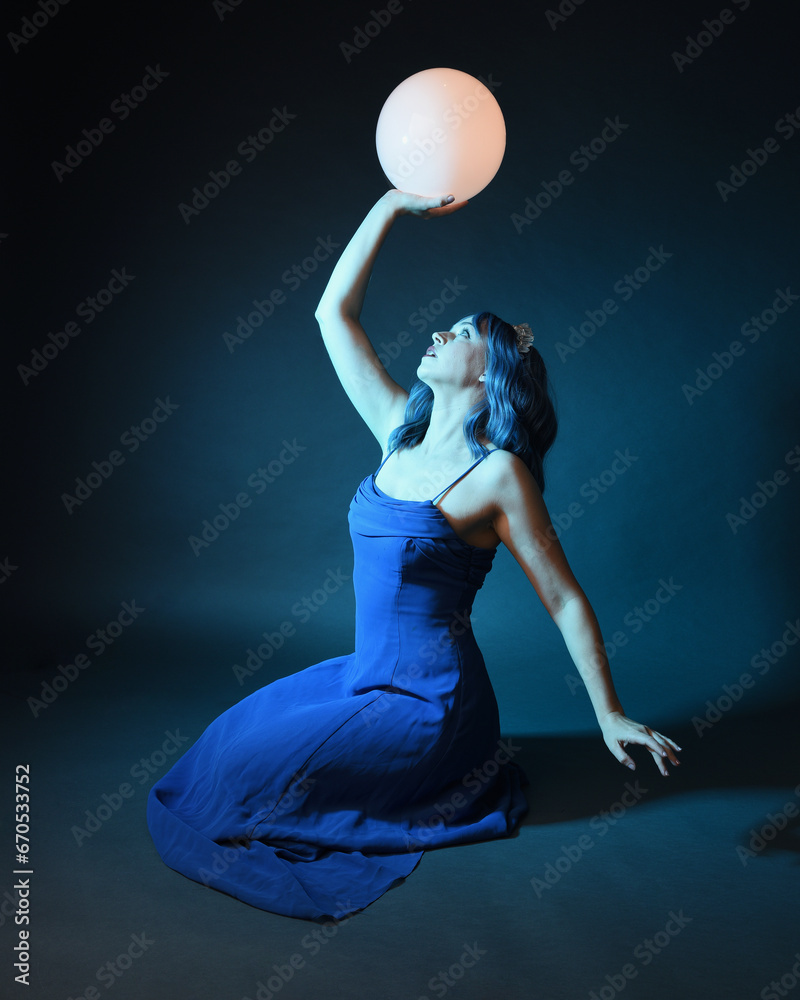 Full length portrait of beautiful female model wit blue hair wearing ...