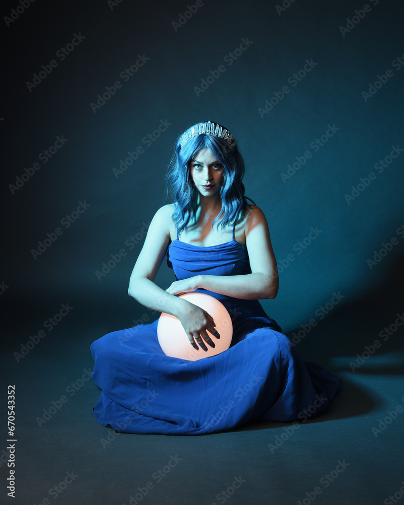 Full length portrait of beautiful female model wit blue hair wearing ...