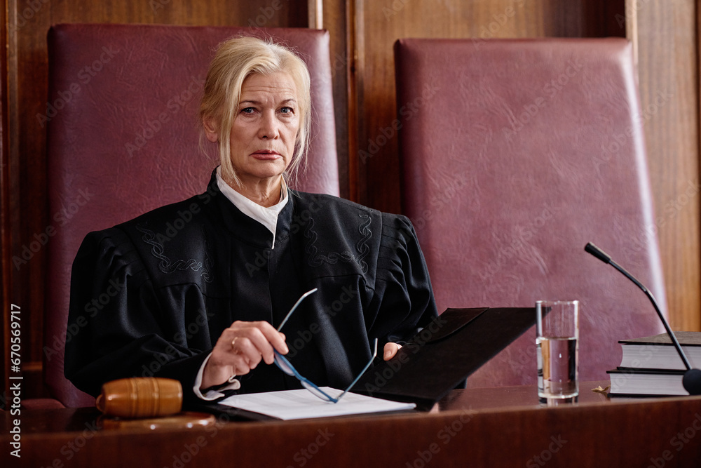 Serious mature blond female judge of supreme court of justice in black ...