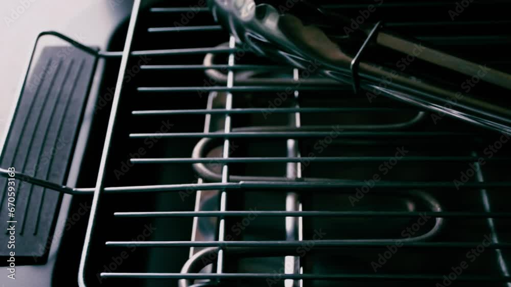 A cinematic style showing of a new electric grill on a countertop. The ...