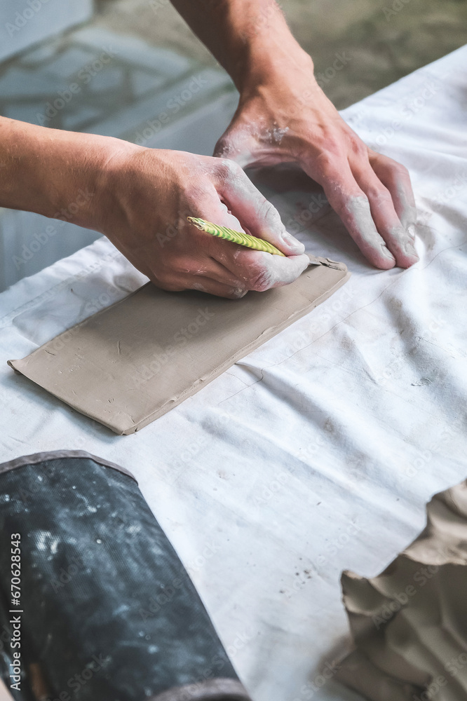 Potter makes dishes from clay, ceramics.Craft,work by hand in the ...