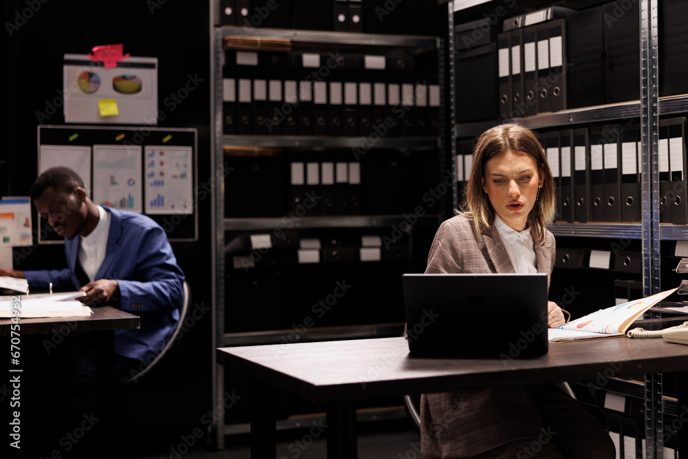 Caucasian inspector analyzing surveillance footage from victim house ...