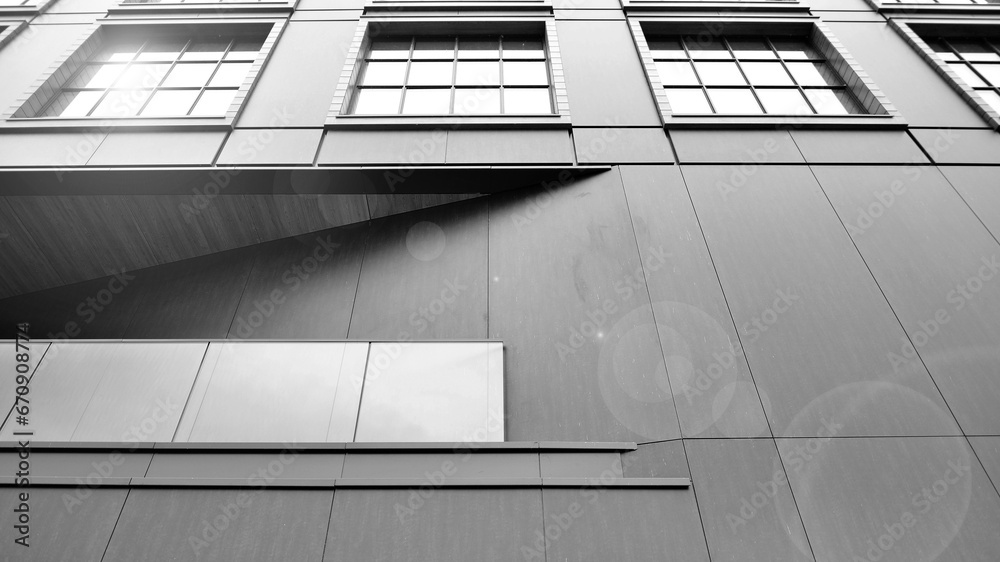 A view at a straight facade of a modern building with a dark grey ...