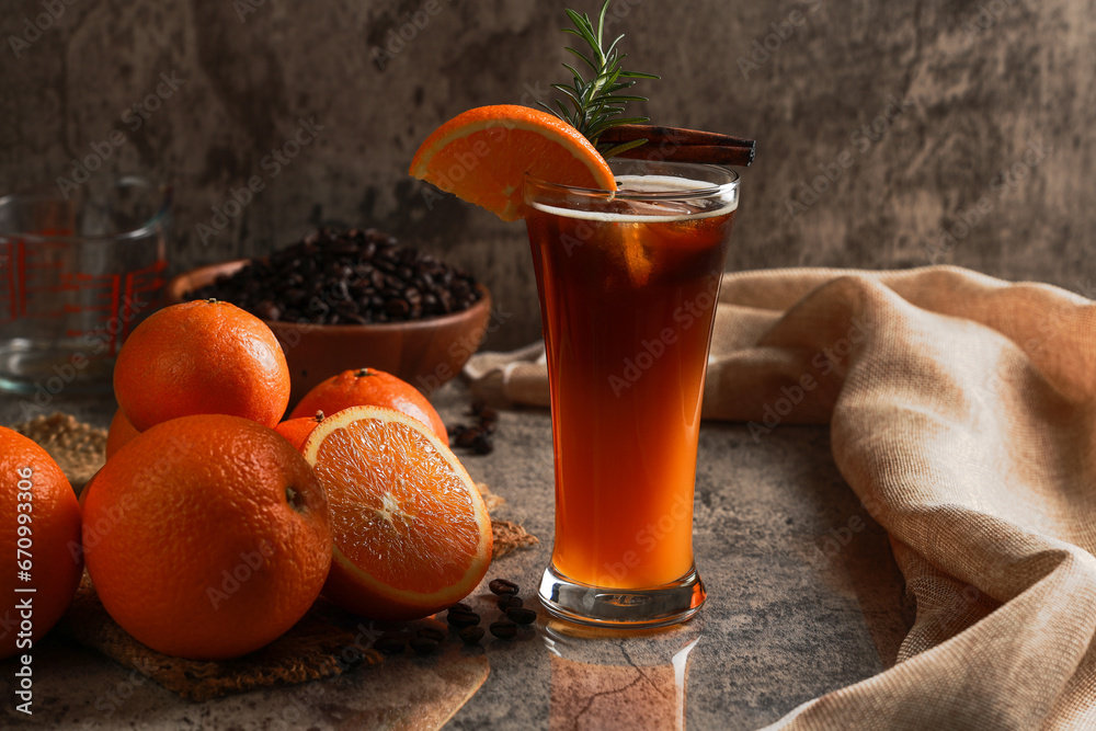 Iced Americano black coffee with lower layer orange juice in the glass ...