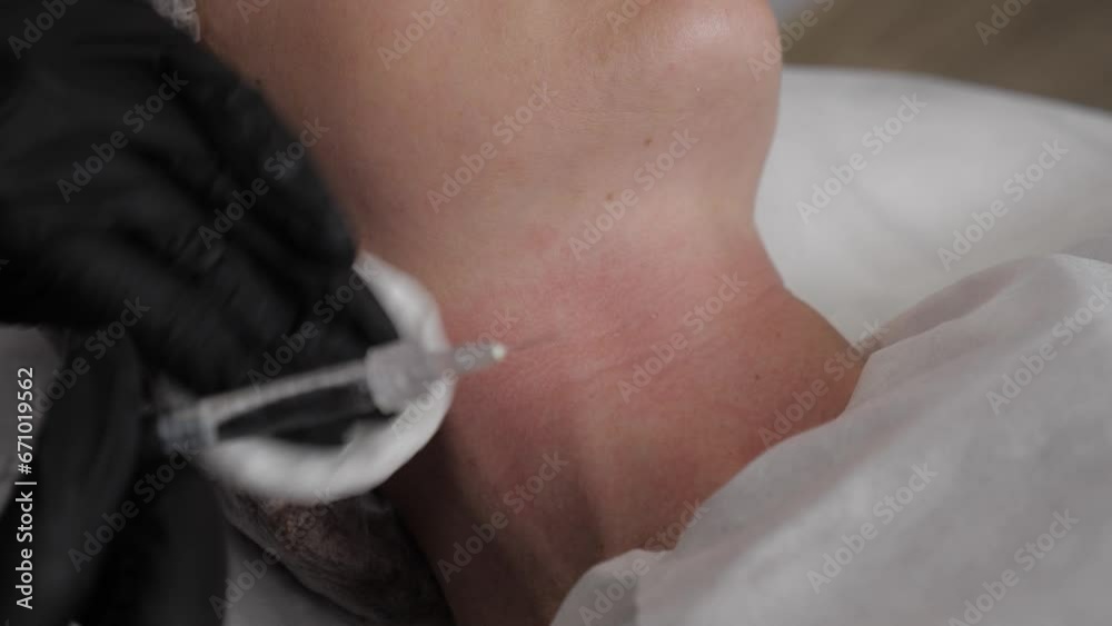 close up injection under the skin with a needle. wrinkles on the neck ...