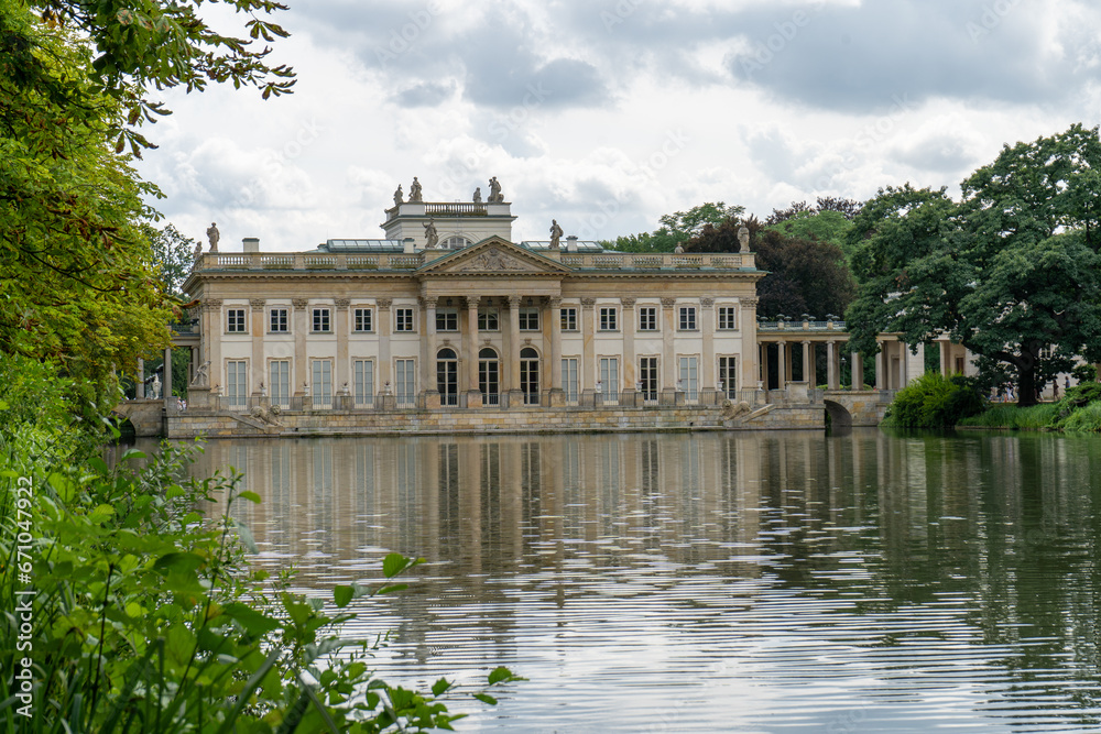 Lazienki Park with pond. Polish Lazienkowski or Lazienki Krolewskie is ...