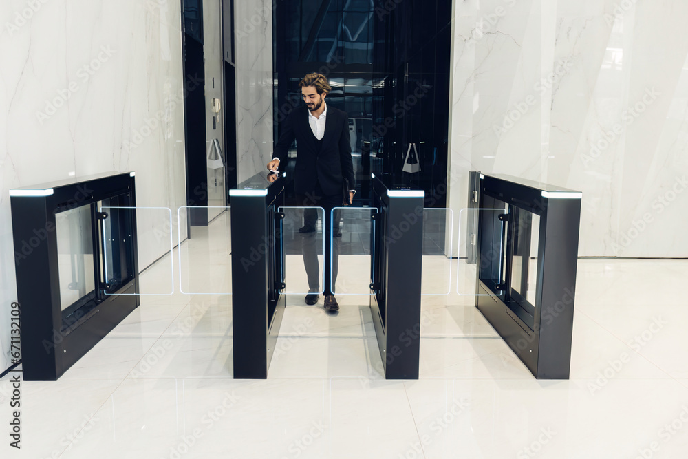 Businessman using card to open automatic gate machine in office ...