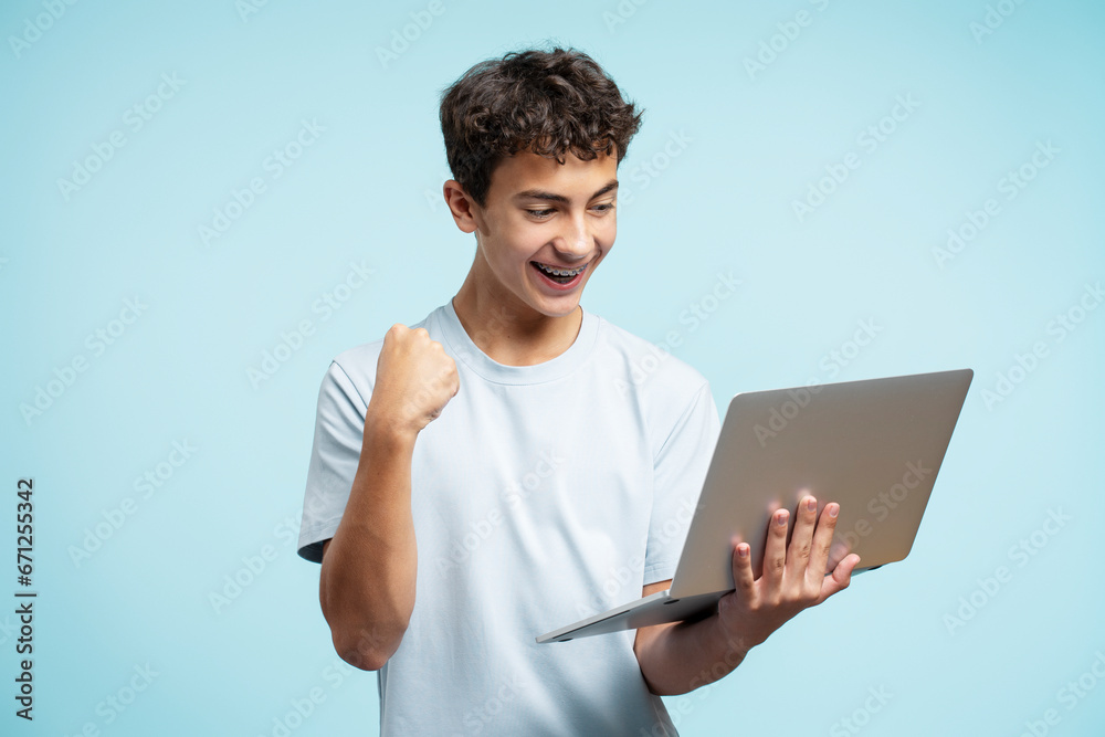 Portrait of smiling handsome teenage boy wearing dental braces holding ...