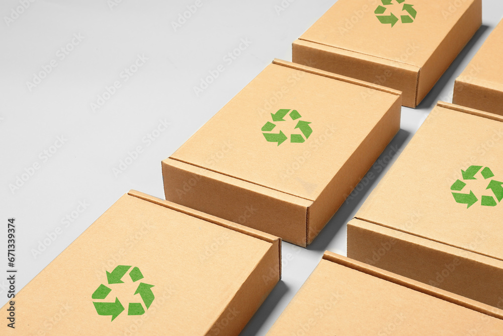 Cardboard boxes with recycle sign stamps on light grey background ...