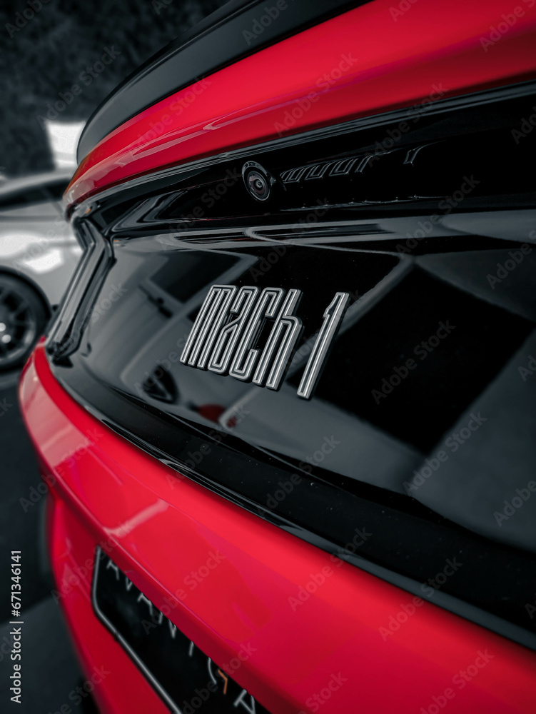 Rear end view of a red Ford Mustang Mach 1, model badge focused shot ...