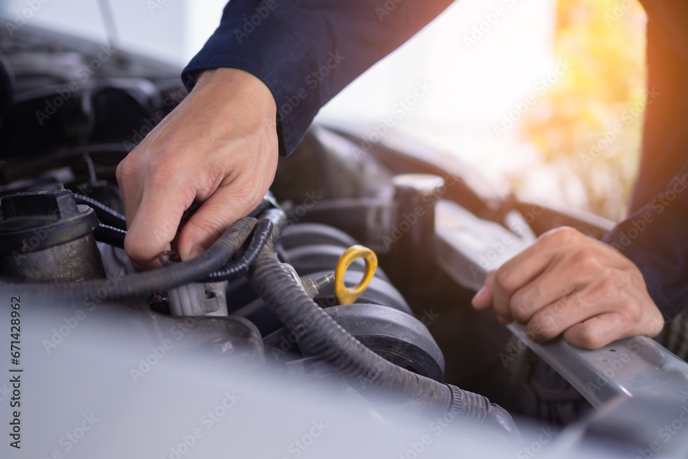 mechanic is doing the annual car inspection. Car repair shop is ready ...