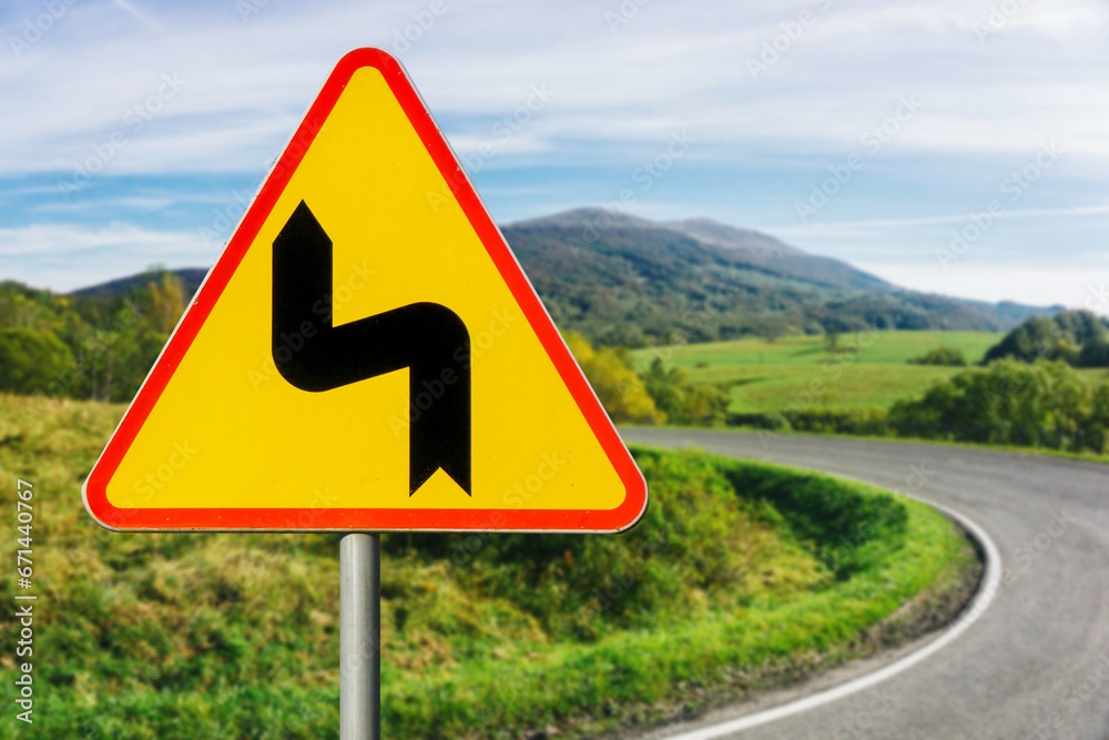 Curvy road landscape. Traffic sign. Road sign. Multiple turns ahead ...