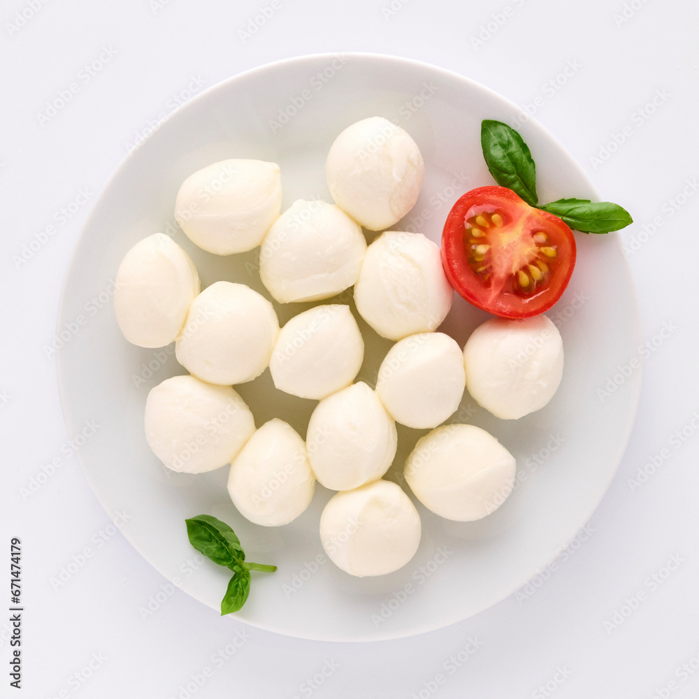 Small balls of mozzarella cheese decorated with cherry tomato and basil ...