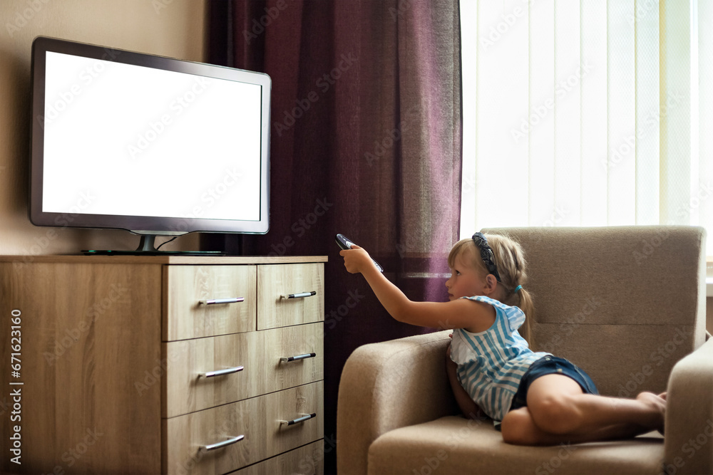 Little girl child 5-6 year old lying down on chair with remote control ...