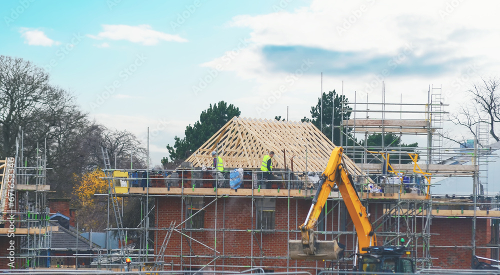 Roofers at work, installation of a new covering of a tiled roof ...
