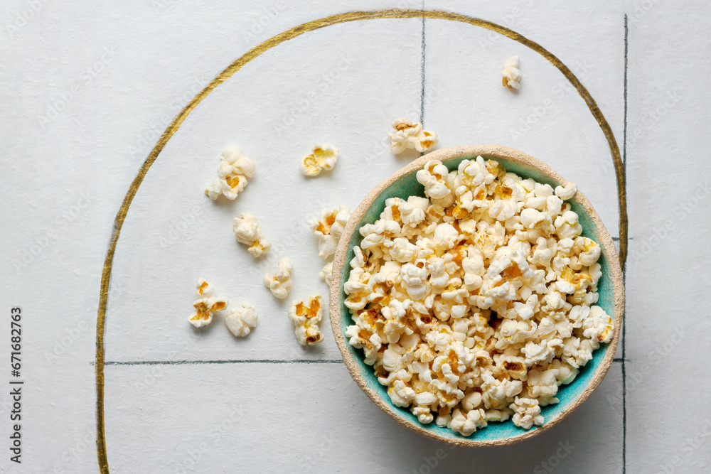 Top view bowl full of popcorn on white background with Fibonacci spiral ...