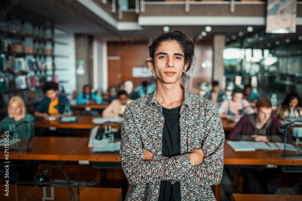 Confident high school student standing in a busy library Stock Photo ...