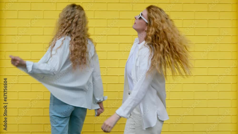 Friends walking dancing outside, woman having fun rhythm to music. Two ...