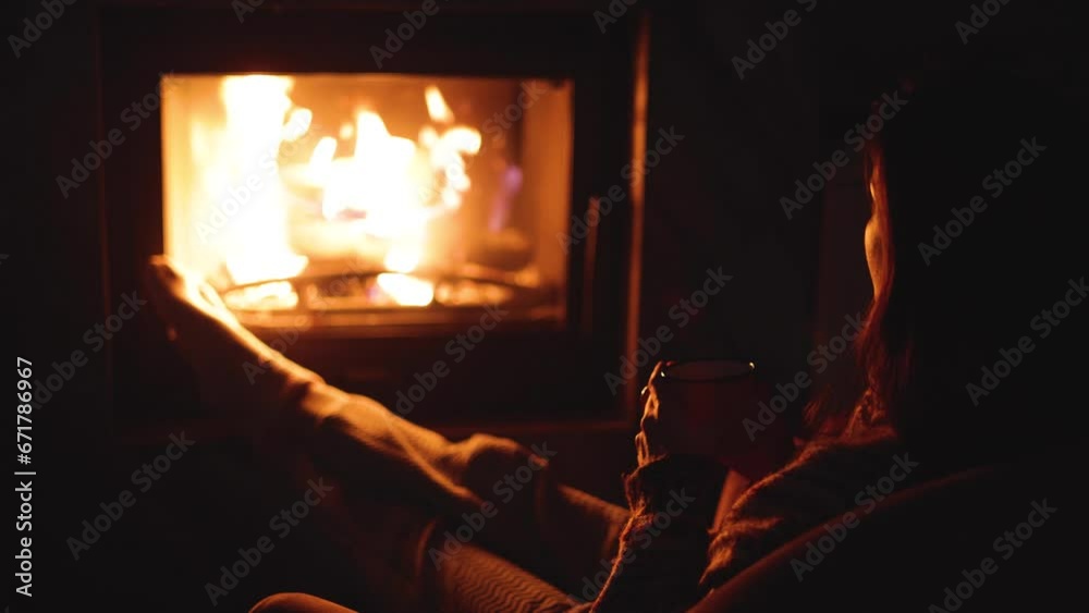 Warming up by the fire, cozy night in the cabin by the fireplace ...