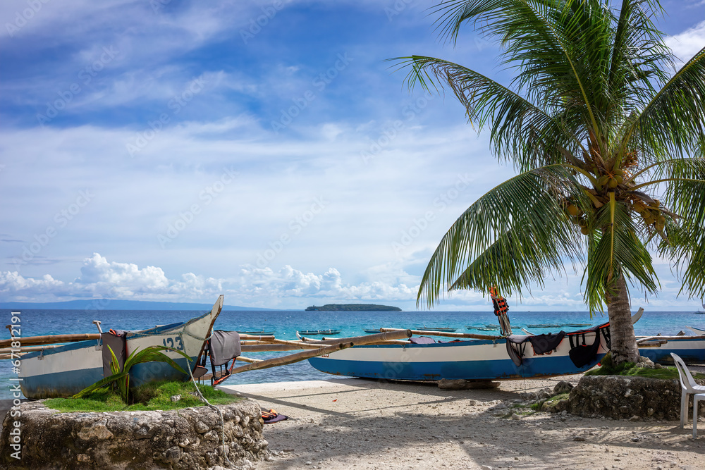 Tropical beach setting with traditional boats anchored ashore. Vivid ...