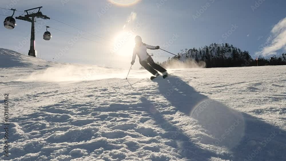 LENS FLARE, SLOW MOTION: Lady sprays snow into camera while skiing on ...