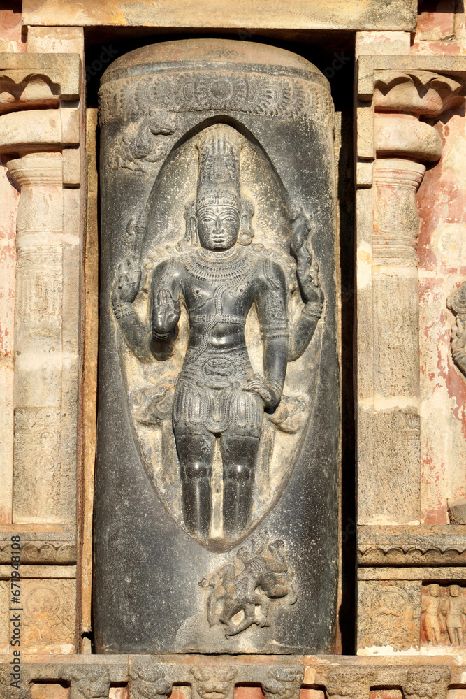 Statue of Hindu God in stone relief Temple wall at Airavatesvara Temple ...