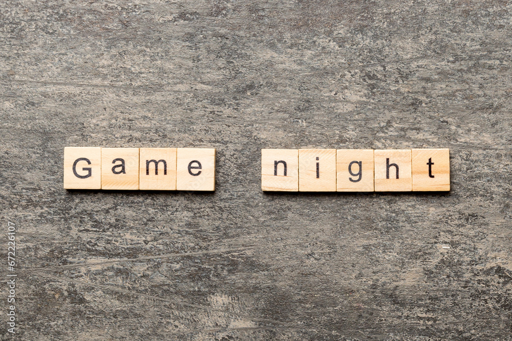 Game Night word written on wood block. Game Night text on cement table ...