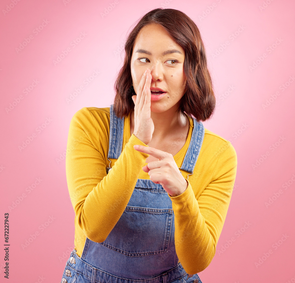 Whisper, hand pointing and asian woman in studio with gossip, drama or ...