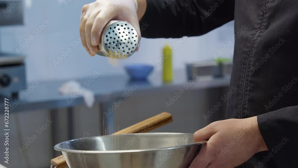 Sprinkling the seasoning on french fries before the cooking process ...