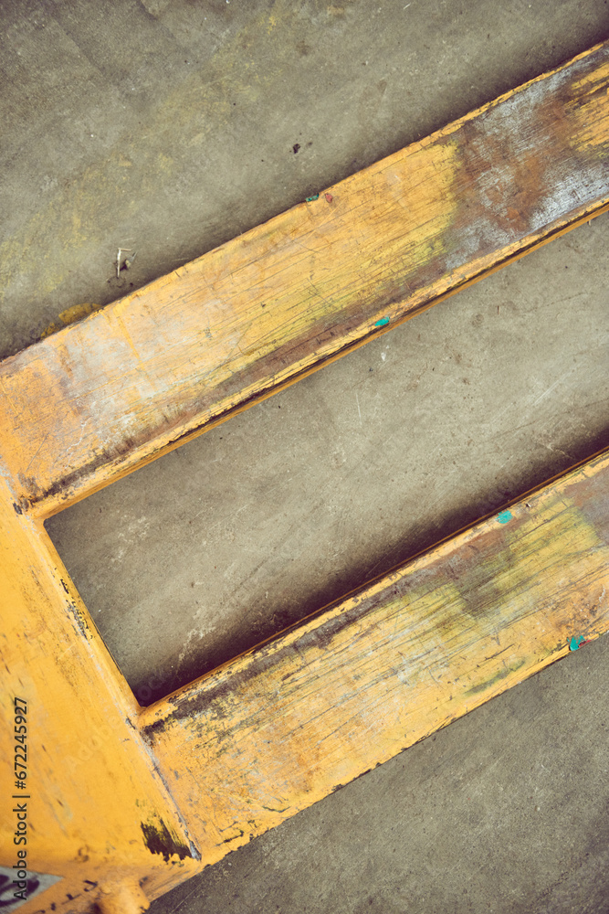 A hard yellow industrial machinery metal texture background, showing ...