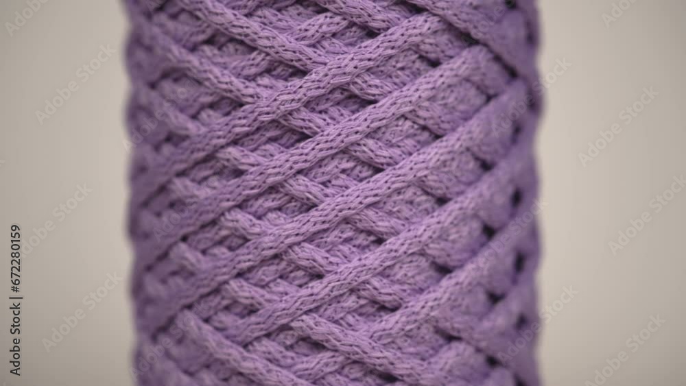 knitting cord. The cord rotates in a circle of purple color.High ...