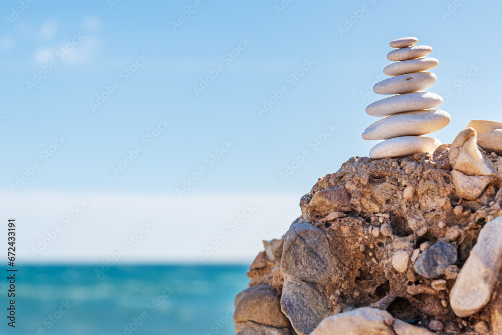 Pyramid of white stones facing the sea, apachetas, concept of yoga and ...