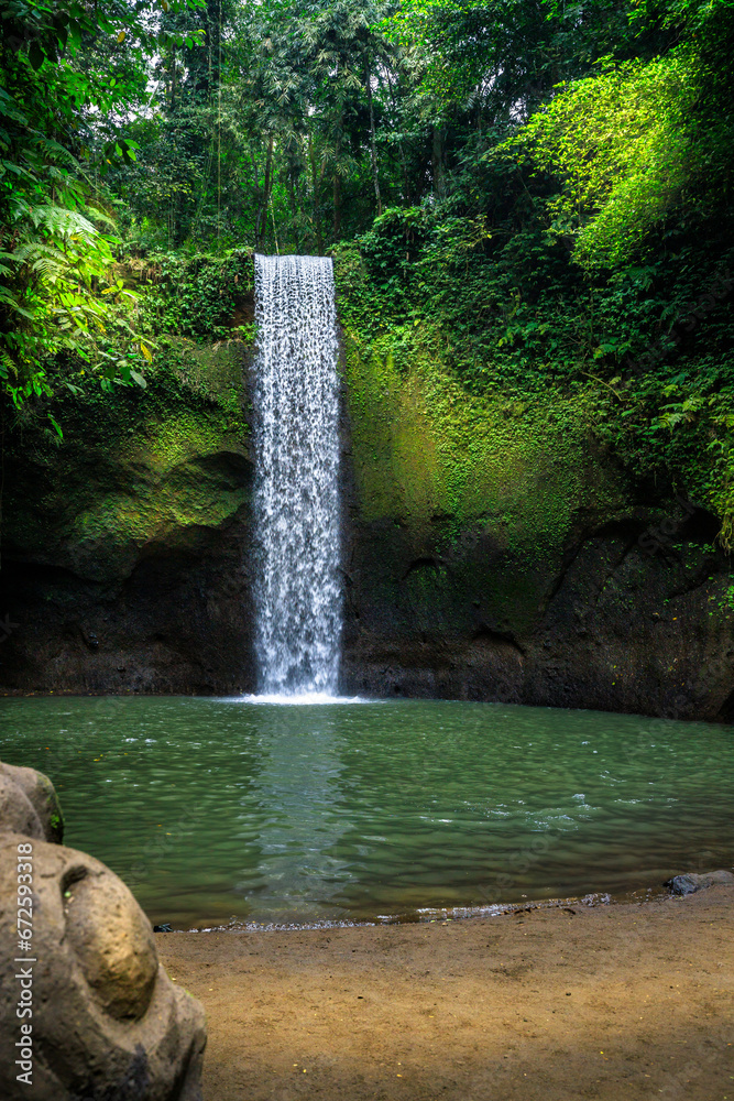 Tibumana Waterfall a small wide waterfall in a green gorge. The river ...