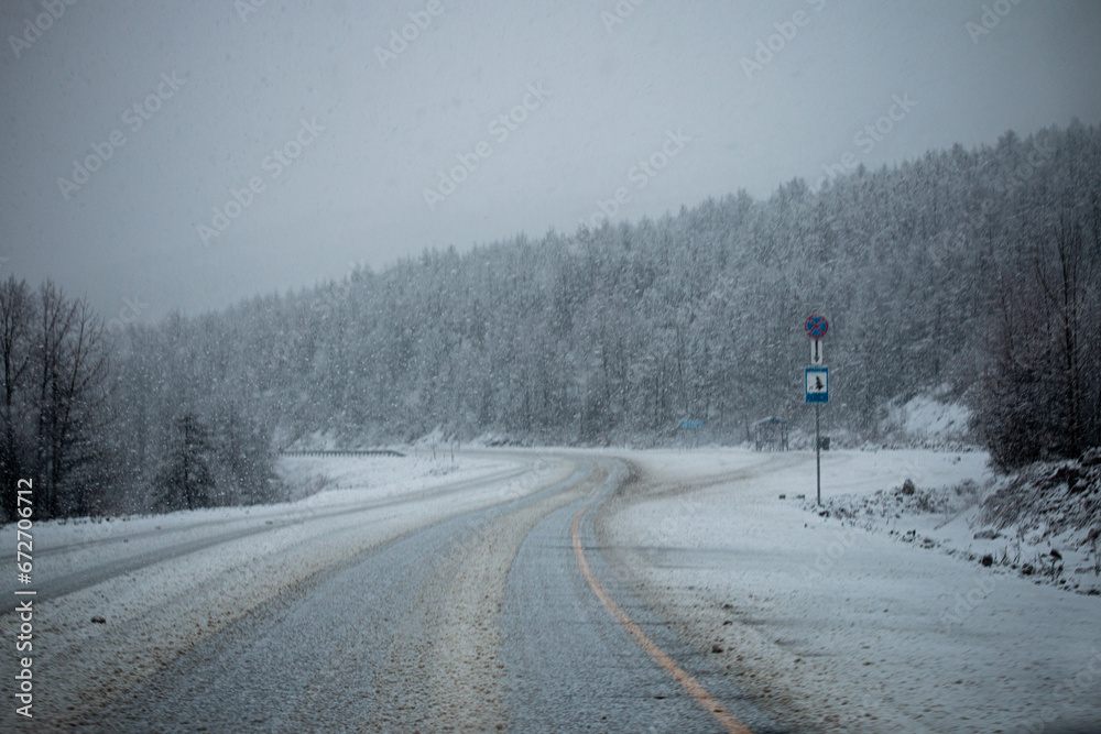 Photo of the winter road during the snowfall in Magadan, Russia. Snow ...