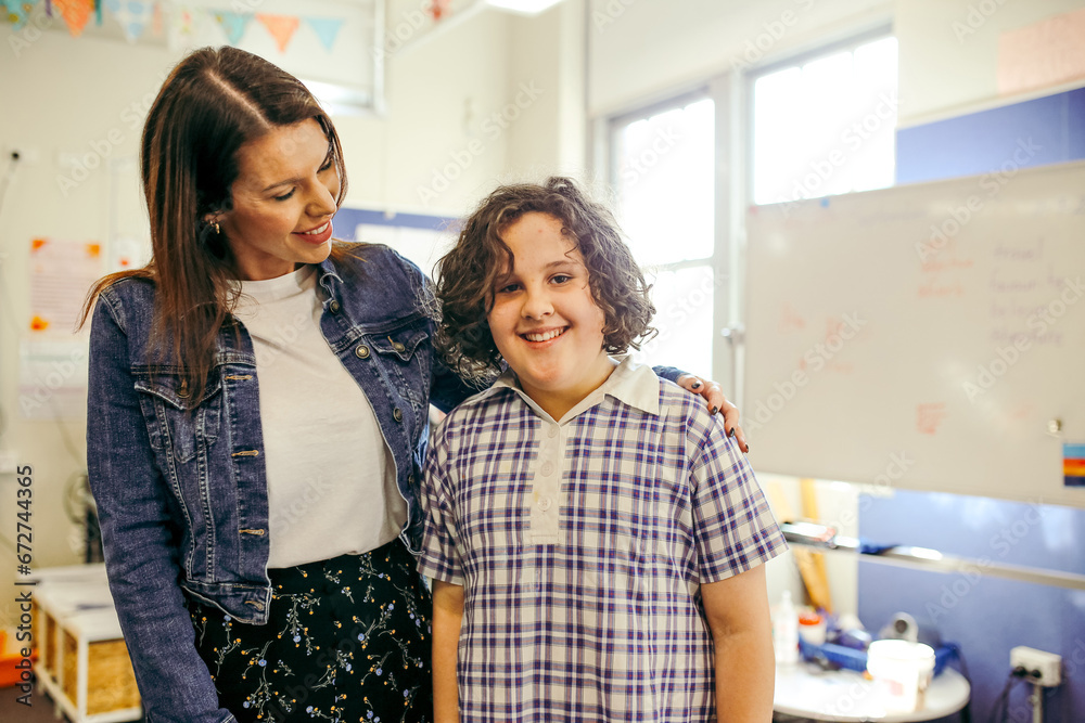Teacher looking fondly at her school student in the classroom Stock ...