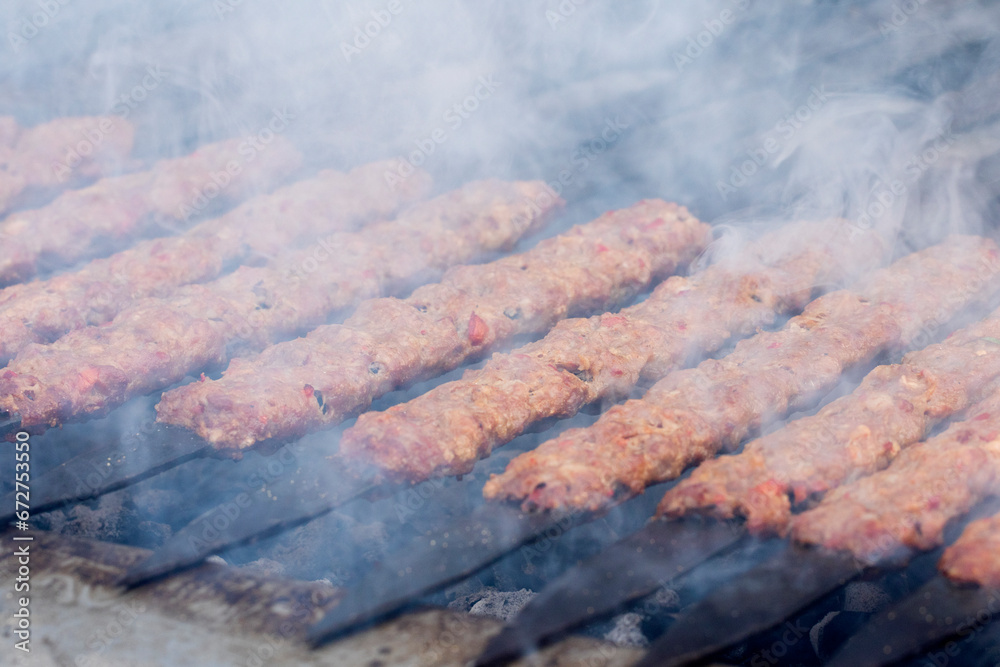 Adana kebab is a famous dish that made with hand-minced lamb meat ...