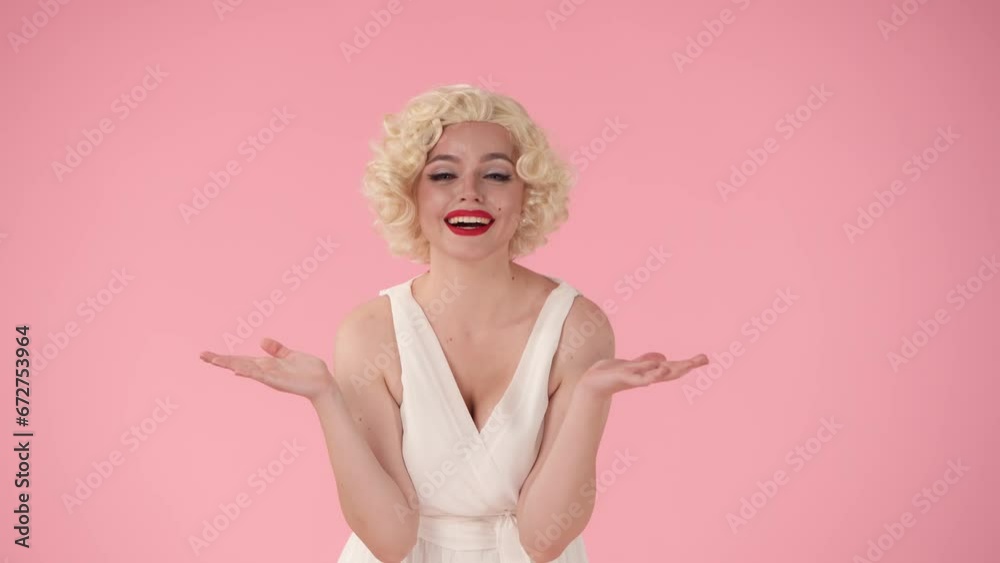 Young woman makes a victory gesture in excitement, celebrating her ...
