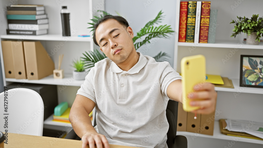 Handsome young chinese man, a serious yet relaxed office worker ...