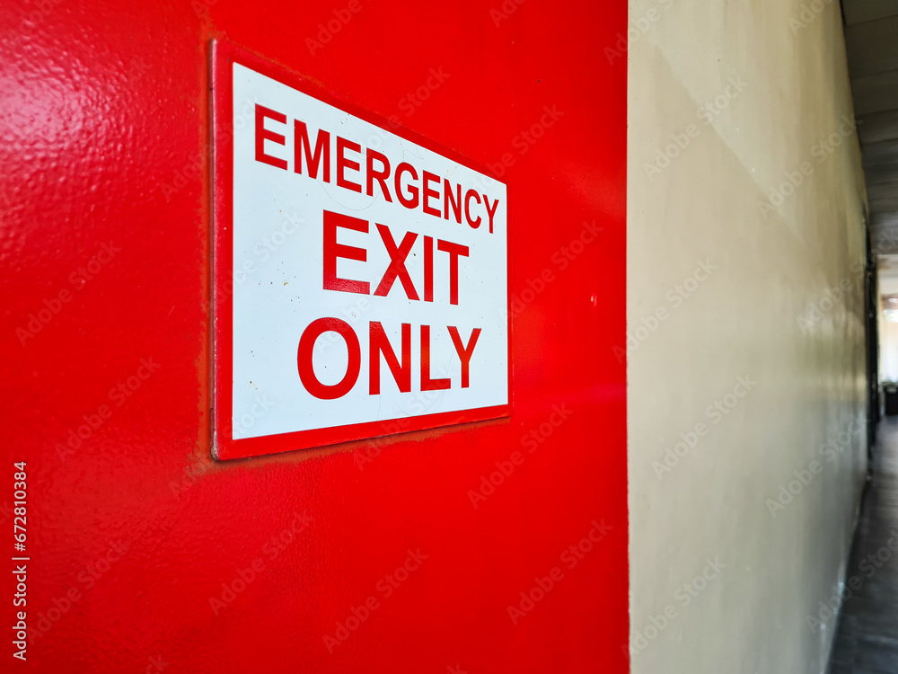 emergency exit signs on red doors in office buildings and malls. Stock ...