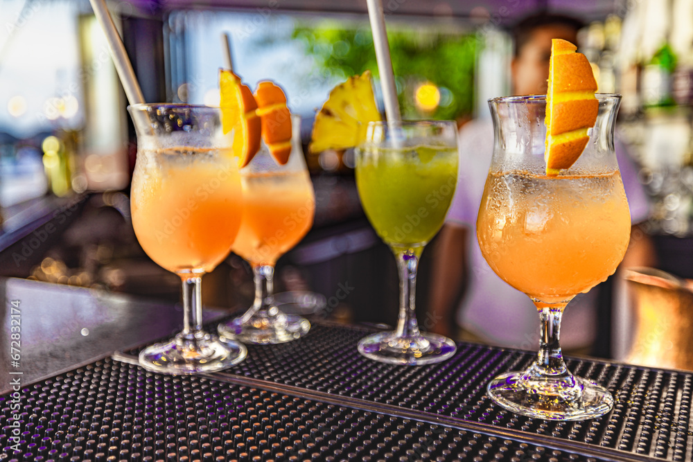 Three different beautiful cocktails in warm colors on a flower ...