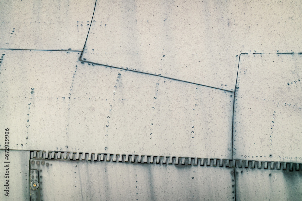 Metal skin of military fighter retro aircraft detail, surface with ...