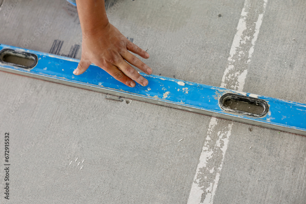 tile layer marking the centerline on the floor with a large level Stock ...