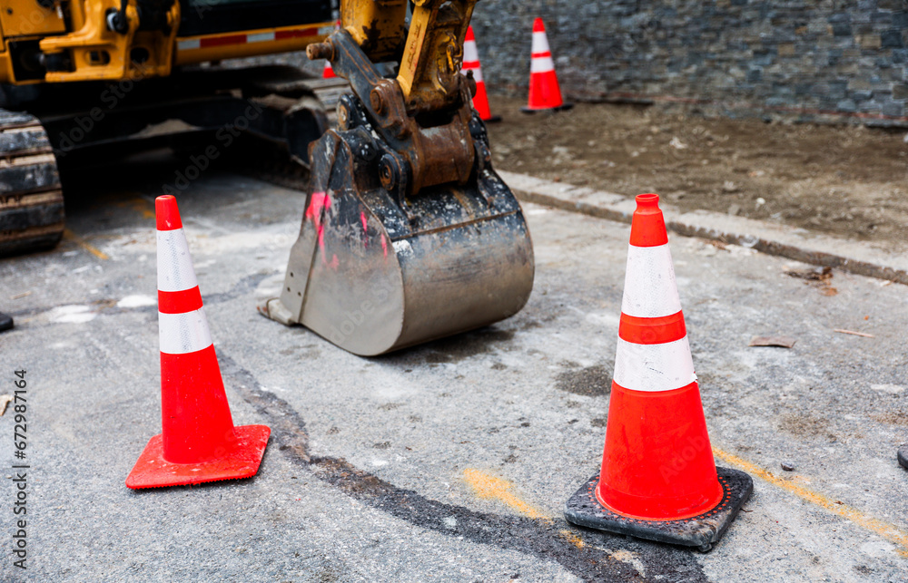 orange construction cones line the urban street, symbolizing safety ...