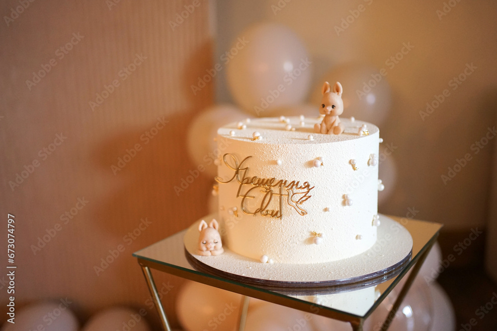 Festive cake with the inscription "Baptism" and a figure of a hare ...