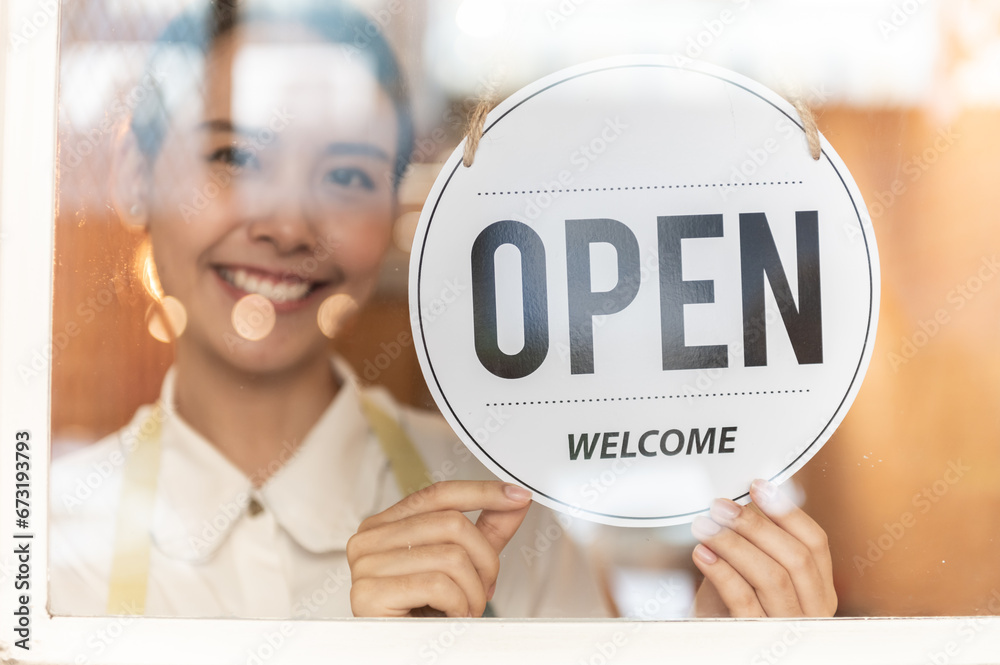 Asian small business owner woman turning shop entrance sign to open on ...