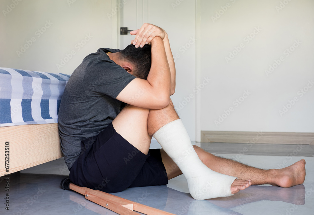 Sad depressed asia man suffering near the bed, he is sitting and ...
