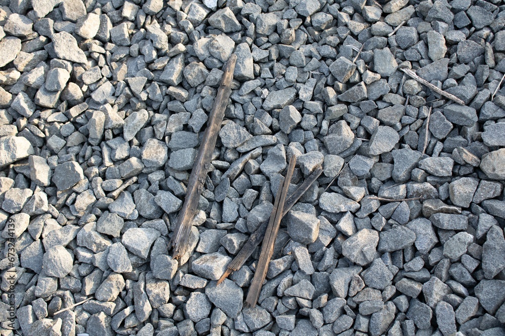Collection of rocks and wooden sticks on the ground in sunlight Stock ...