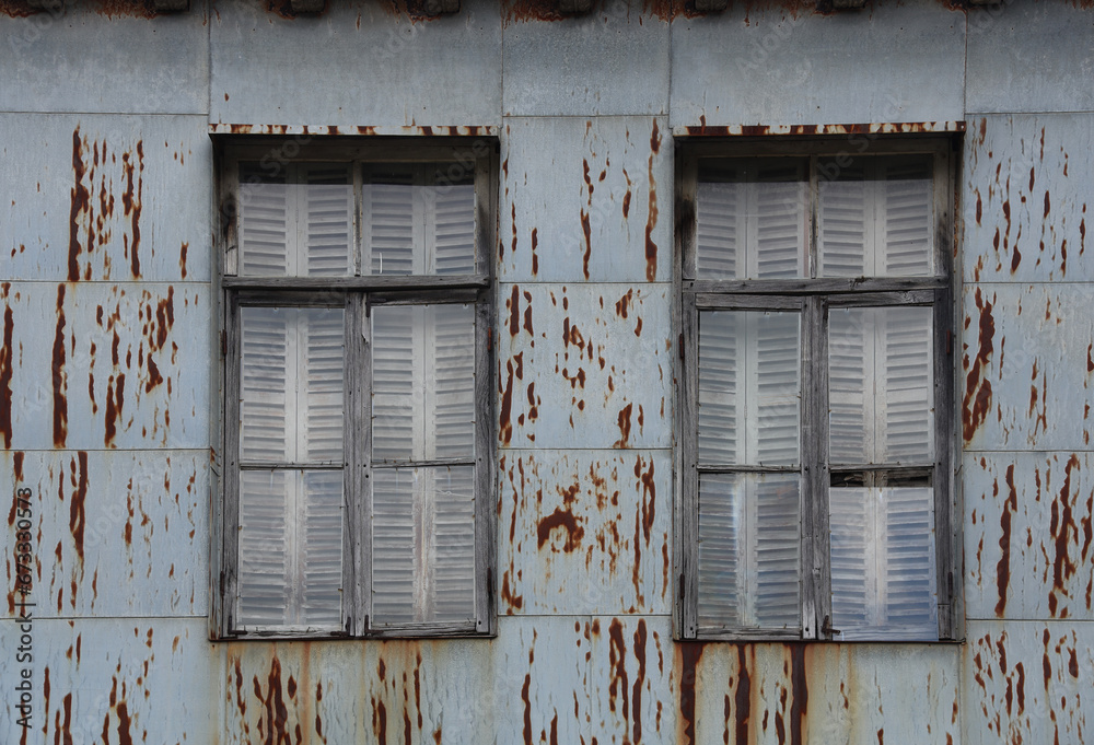 Single-Hung windows on rusty metal wall, exterior view. Kobuleti ...