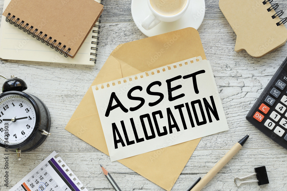 asset allocation text on a page in the middle of the table. desk clock ...