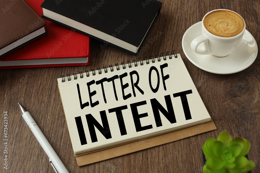 LETTER OF INTENT working environment with notepad and cup of coffee ...